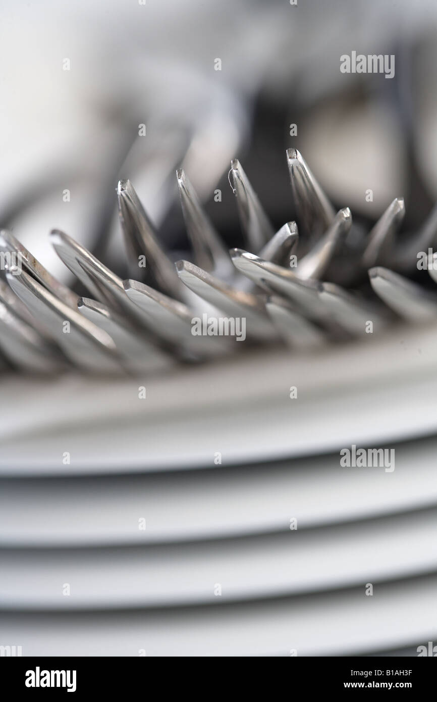 Still life of a stack of plates with cutlery Stock Photo - Alamy