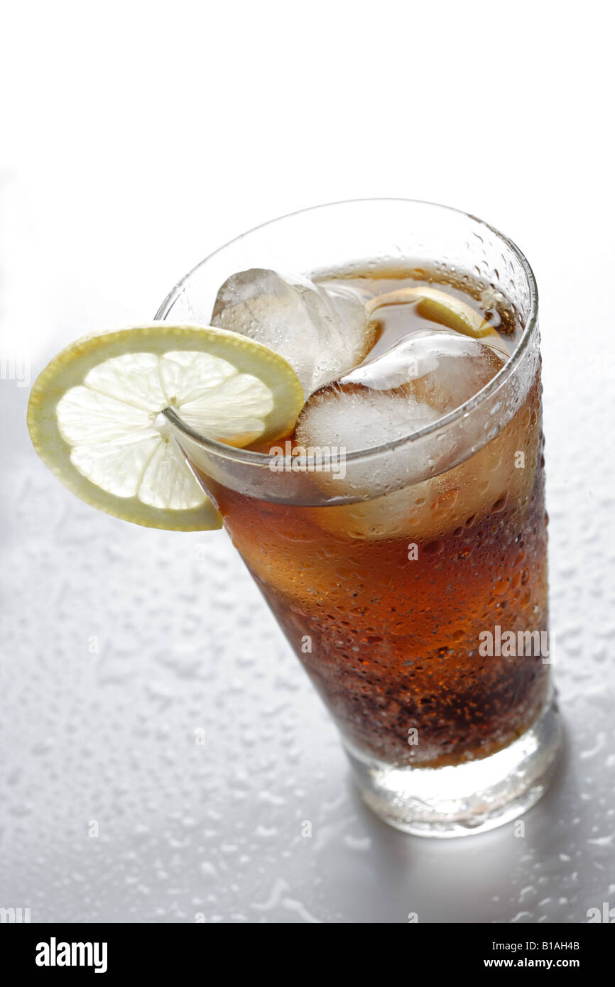 A glass of cola with ice cubes and a slice of lemon Stock Photo - Alamy
