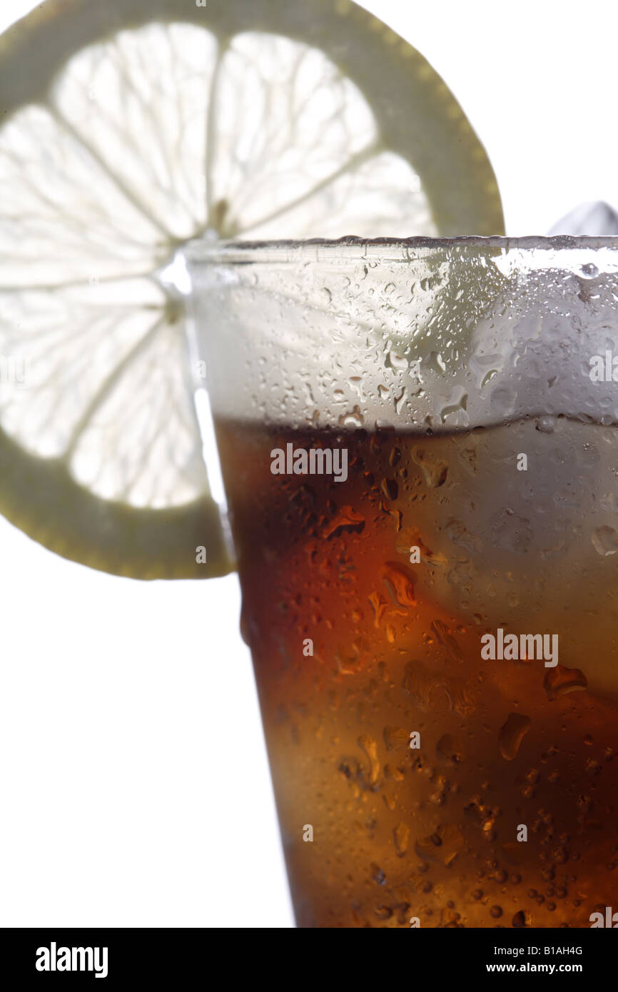 A glass of cola with ice cubes and a slice of lemon Stock Photo - Alamy