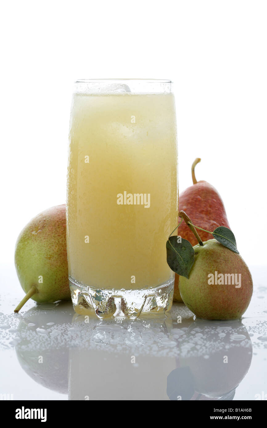 A glass of pear juice with ice cubes and pears on the side Stock Photo ...
