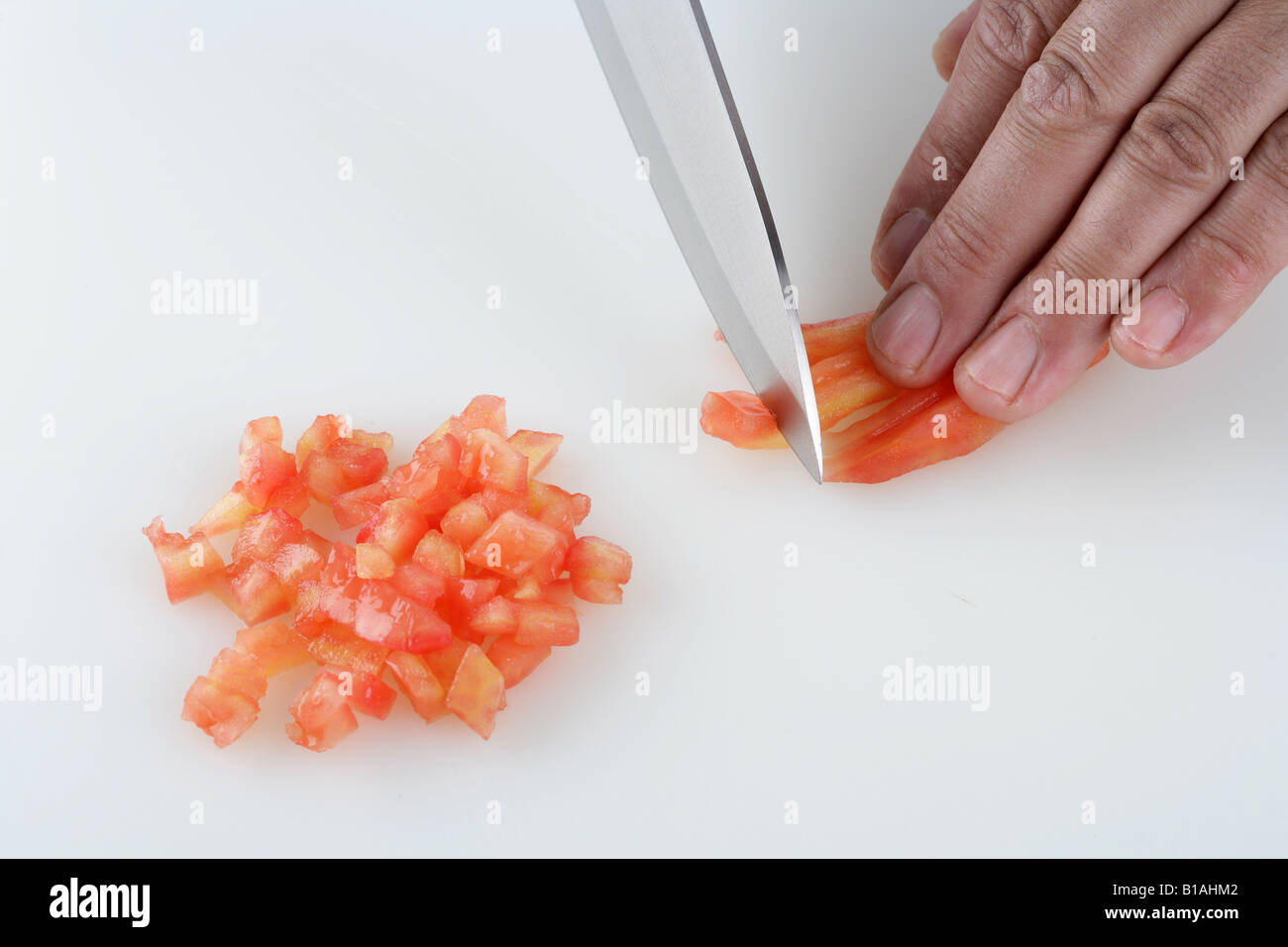 Cutting red tomato small pieces hi-res stock photography and images - Alamy