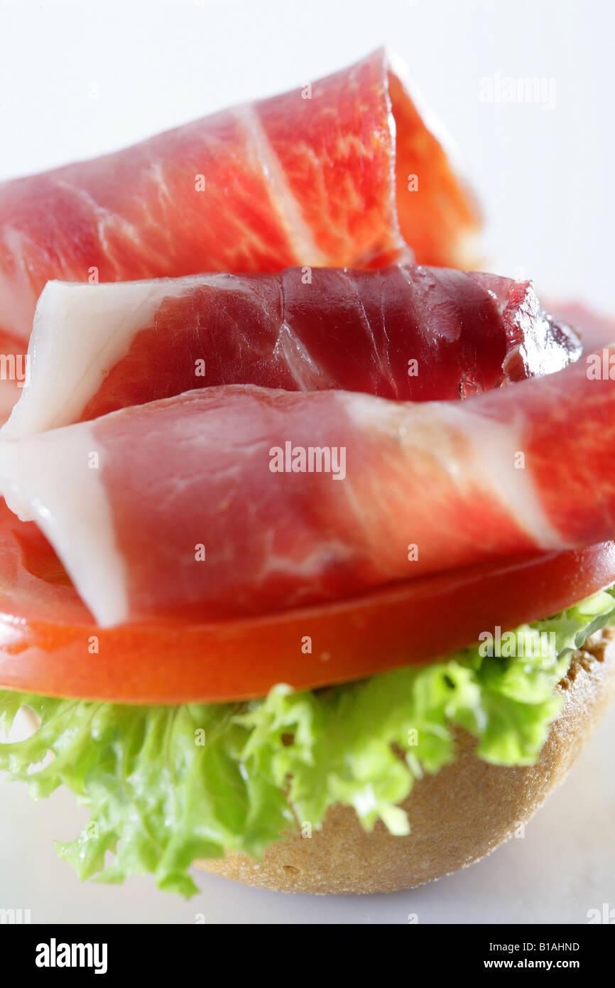 Iberian ham pincho (snack) with lettuce and tomato Stock Photo - Alamy