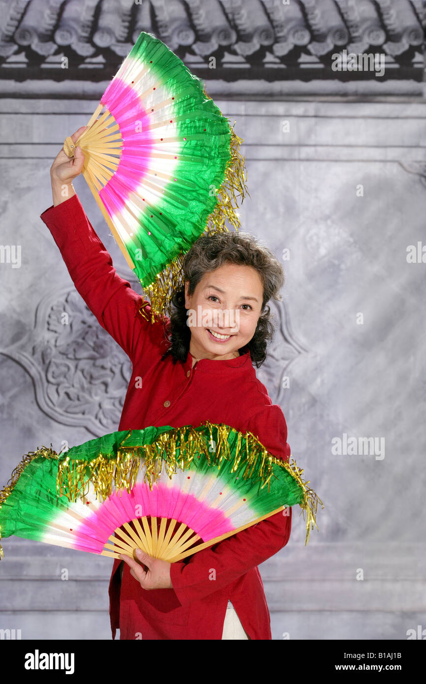 oriental senior woman dancing with fan Stock Photo - Alamy
