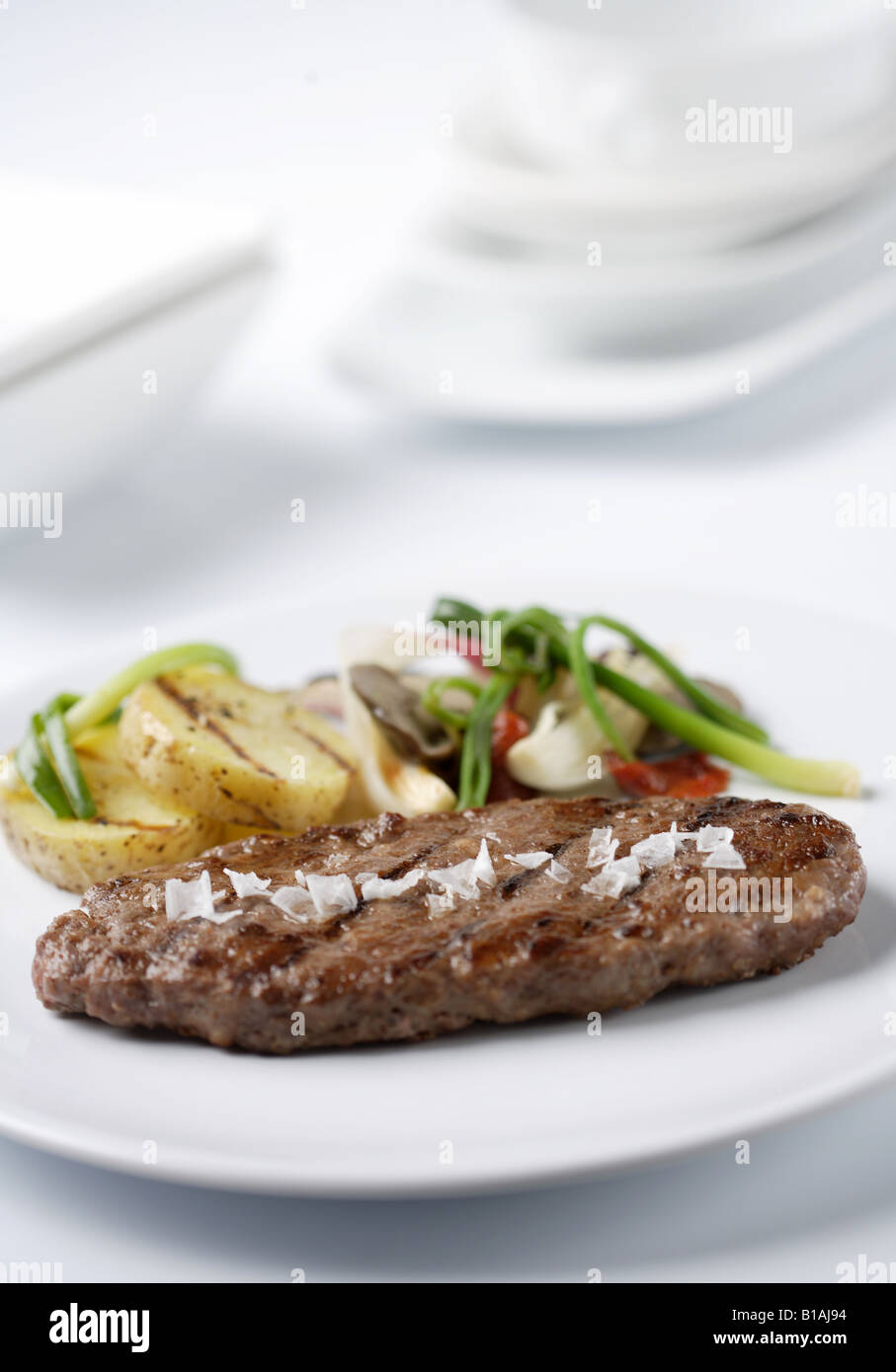 One hamburger with potatoes and grilled vegetables Stock Photo - Alamy