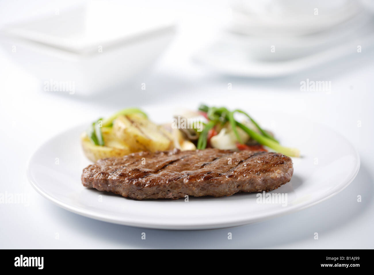 One hamburger with potatoes and grilled vegetables Stock Photo - Alamy