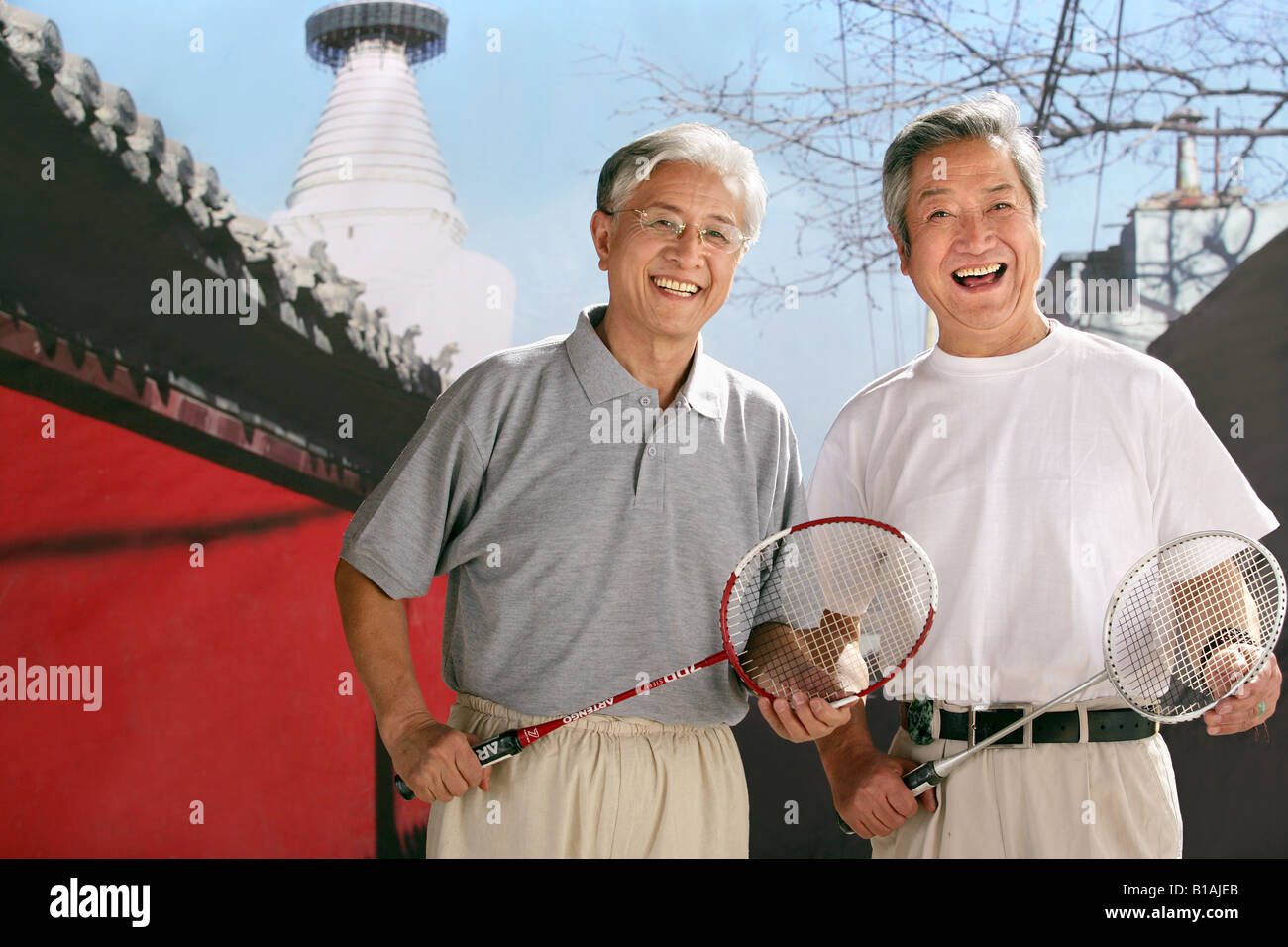 two oriental senior adults playing badminton Stock Photo - Alamy