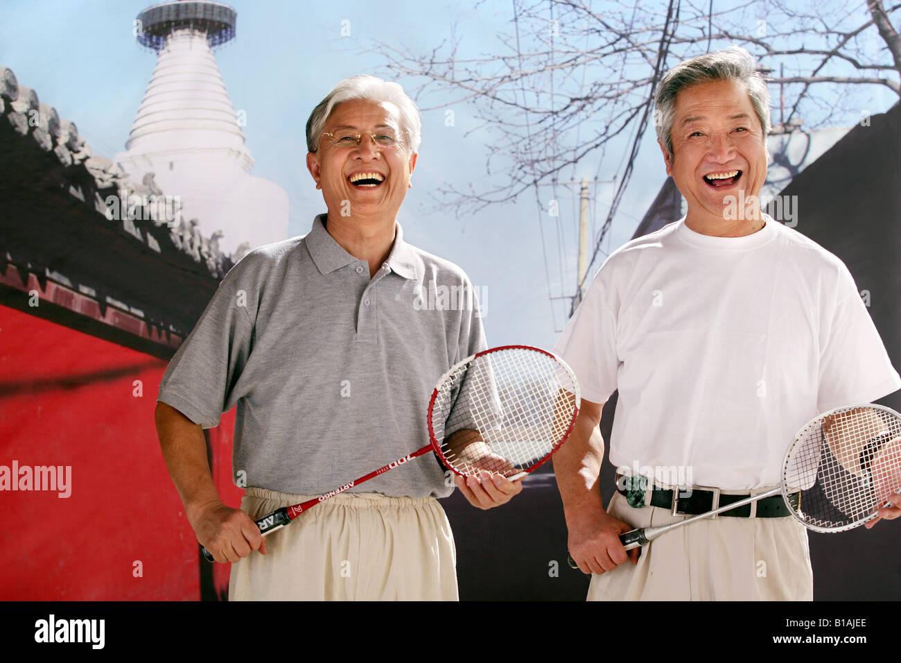 two oriental senior adults playing badminton Stock Photo - Alamy