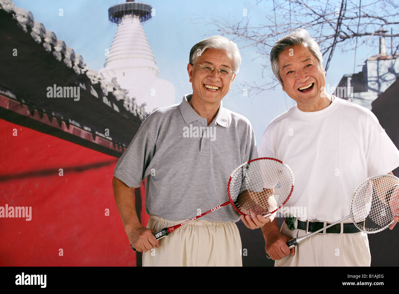 two oriental senior adults playing badminton Stock Photo - Alamy
