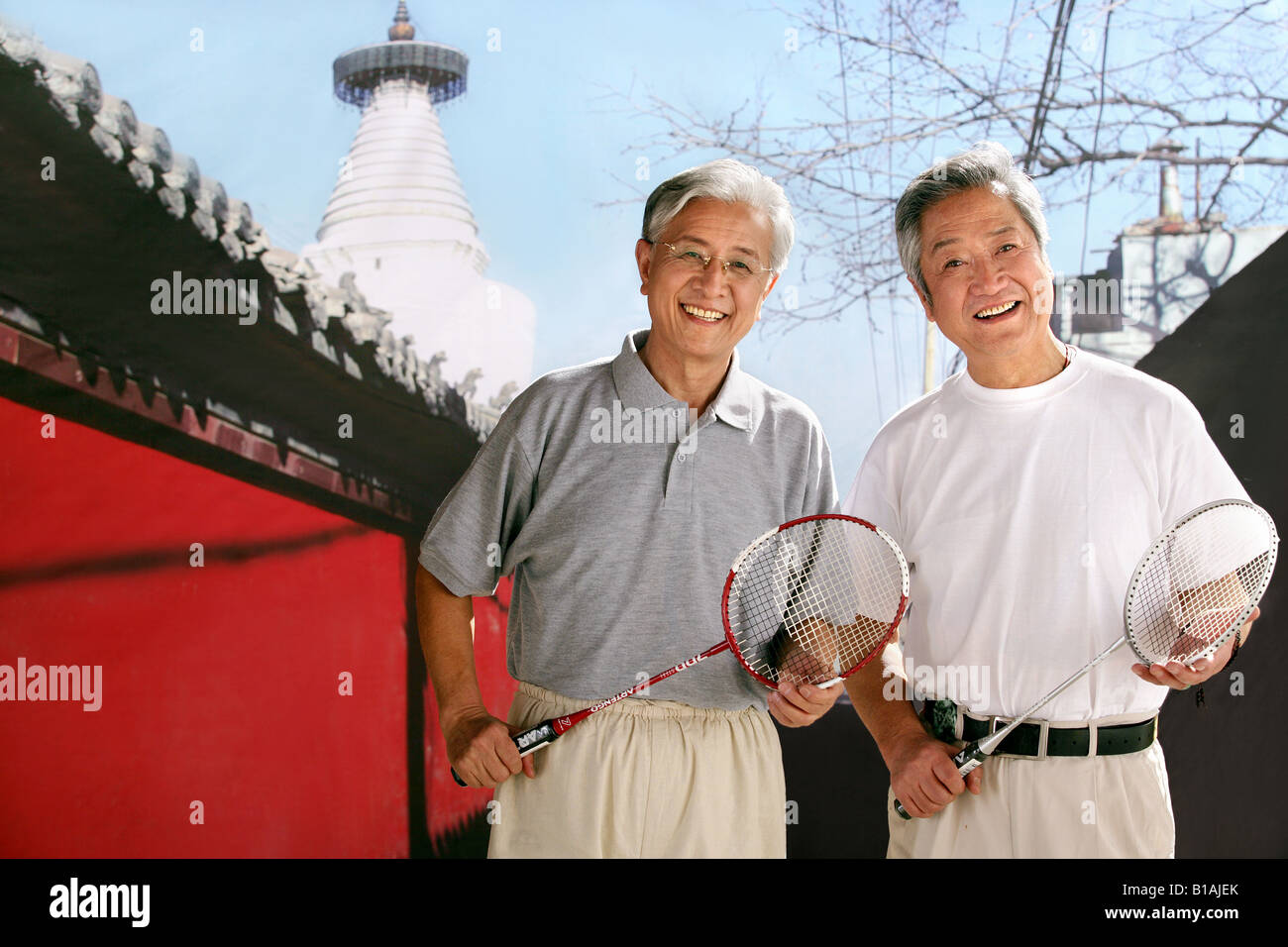 two oriental senior adults playing badminton Stock Photo - Alamy