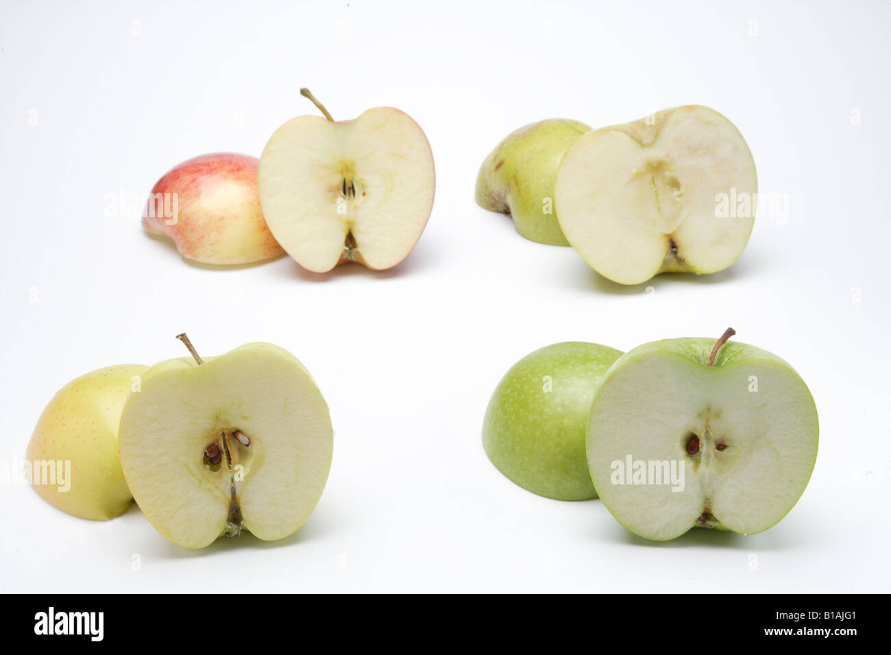 Four apples cut in half Stock Photo - Alamy