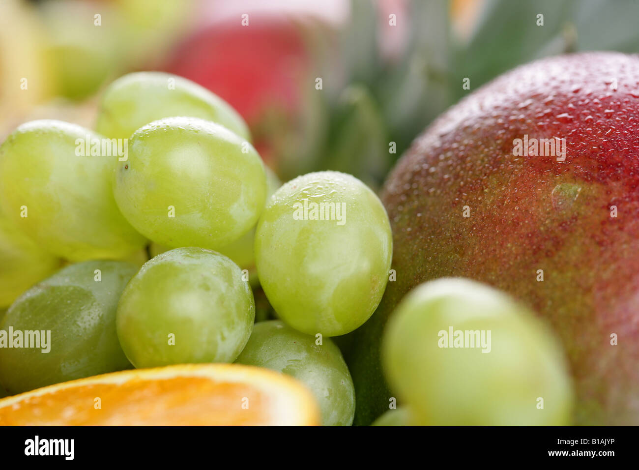 Grapes and mango close up Stock Photo - Alamy
