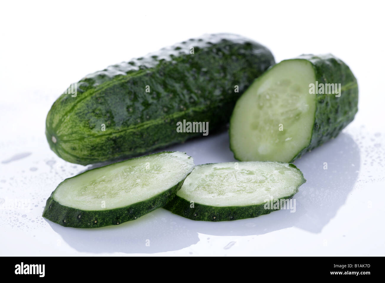 Whole cucumber with slices Stock Photo - Alamy
