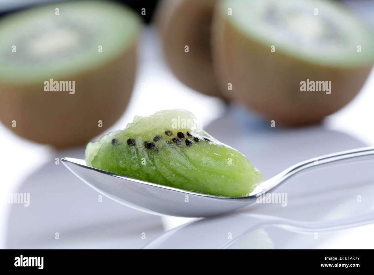 Piece of kiwi on a spoon Stock Photo - Alamy