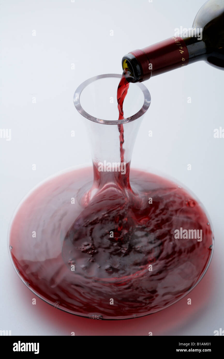 Serving wine in a wine decanter jar Stock Photo - Alamy