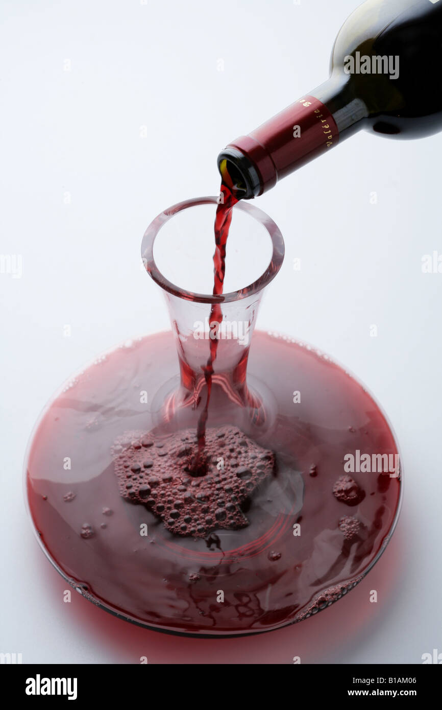 Serving wine in a wine decanter jar Stock Photo - Alamy