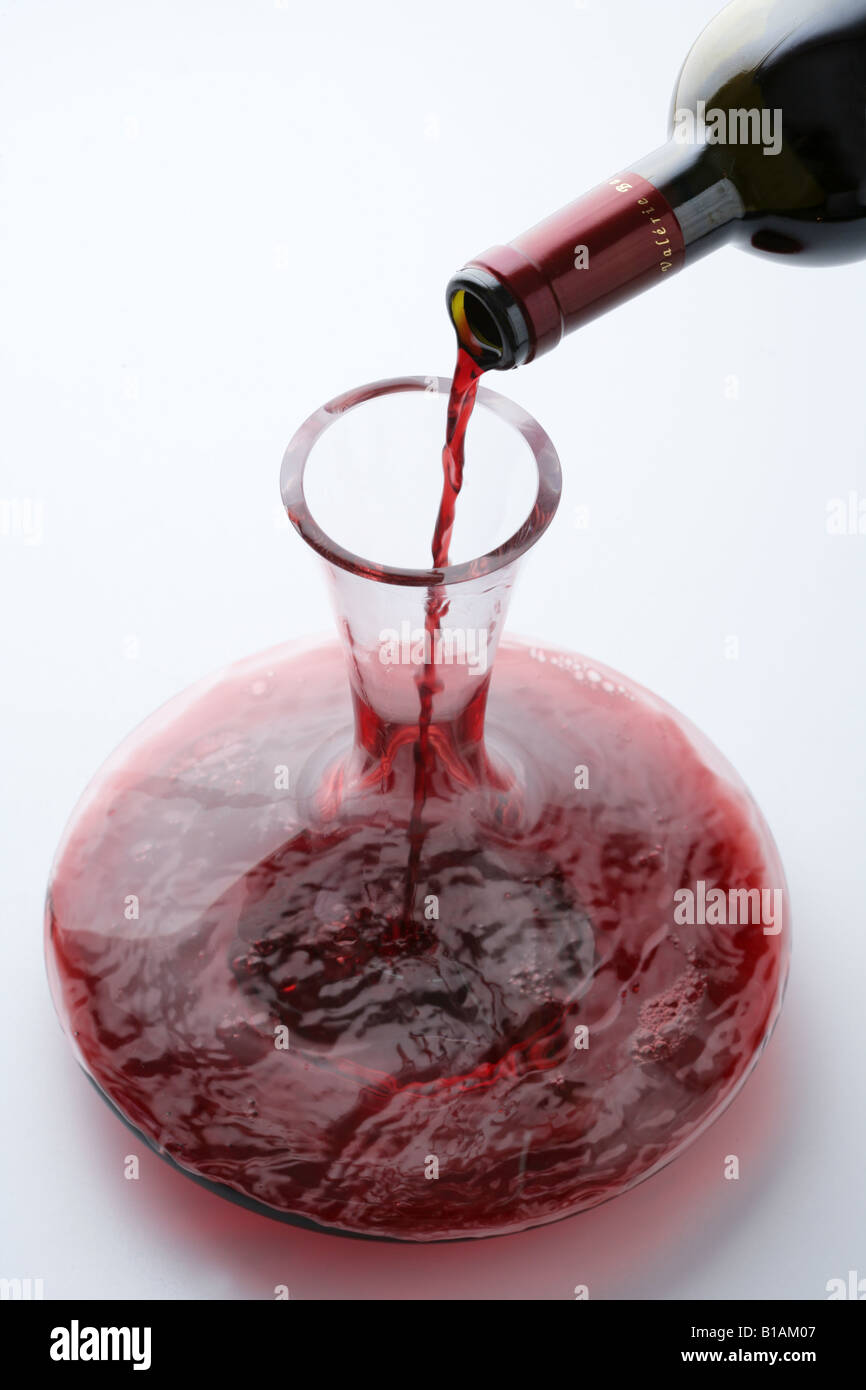 Serving wine in a wine decanter jar Stock Photo - Alamy