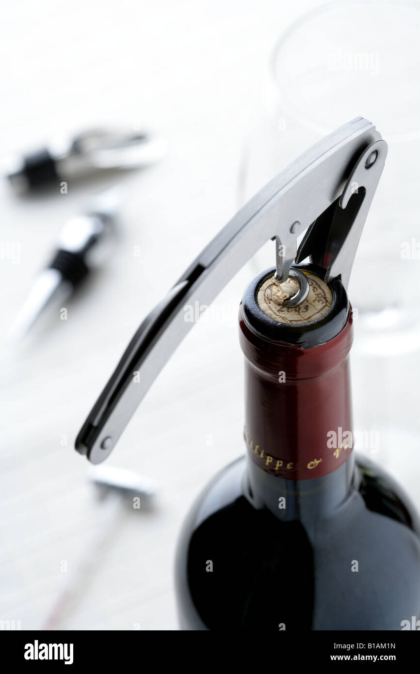 Corkscrew on a red wine bottle Stock Photo - Alamy