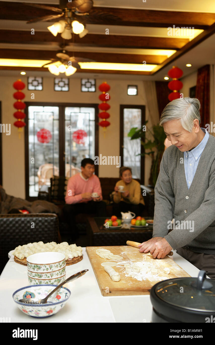 Chinese mature man make Chinese dumpling on New Year's Eve Stock Photo ...