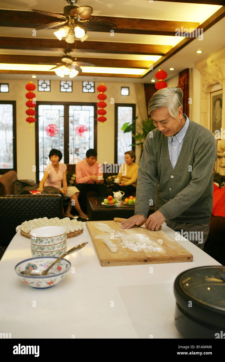 Chinese mature man make Chinese dumpling on New Year's Eve Stock Photo ...