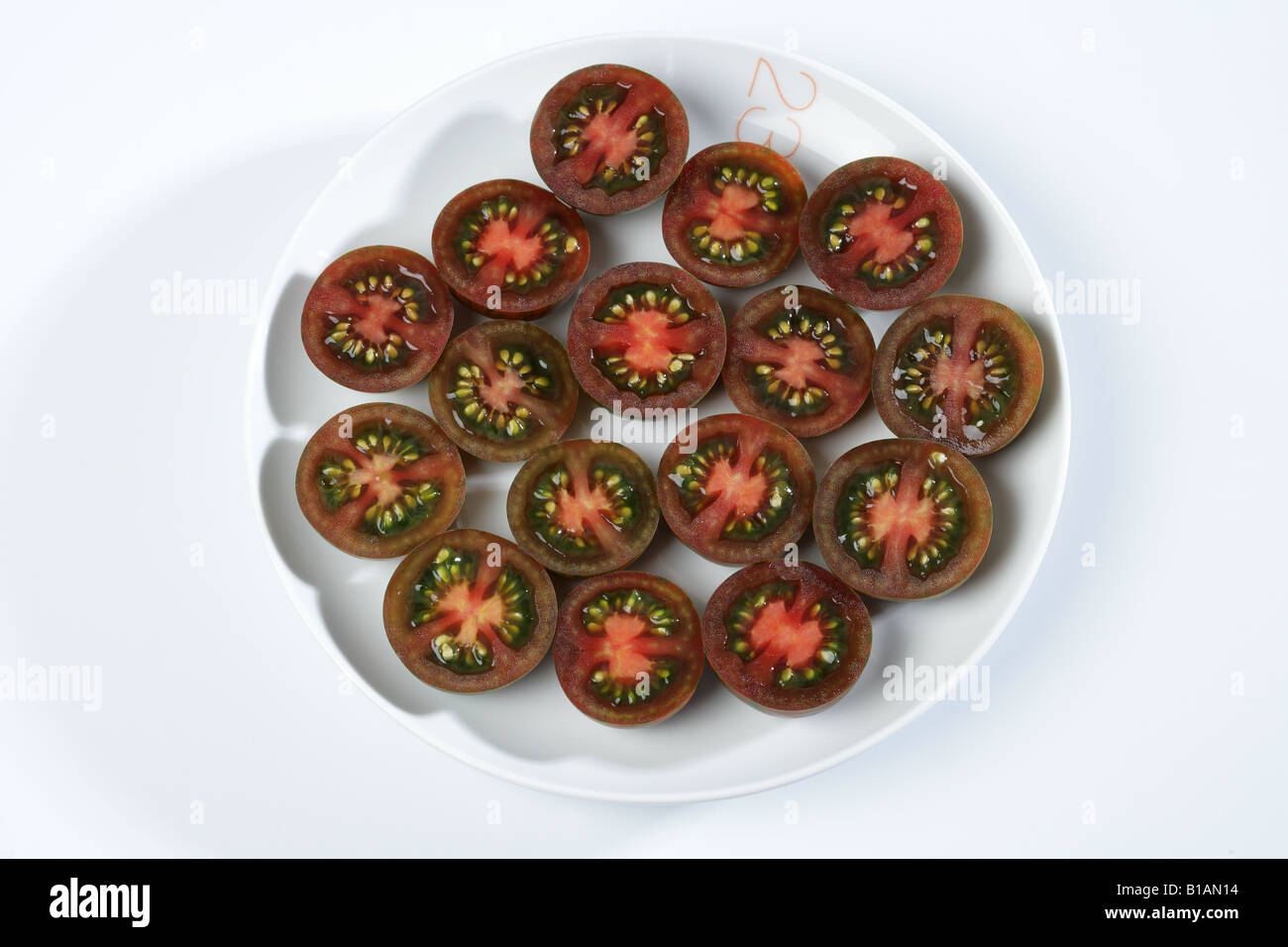 Tiger-striped tomatoes cut in half (zenithal view Stock Photo - Alamy