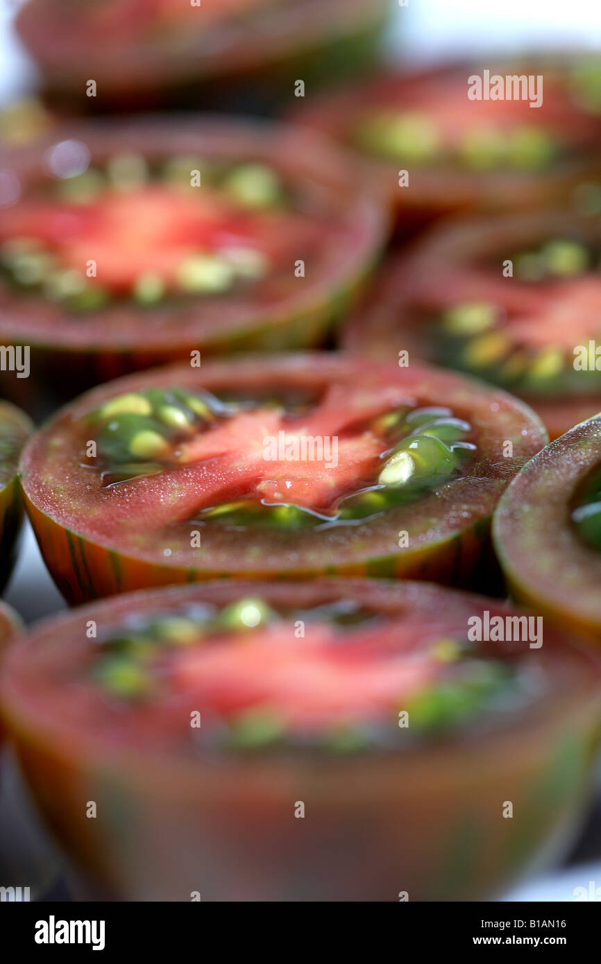Tiger-striped tomatoes cut in half Stock Photo - Alamy