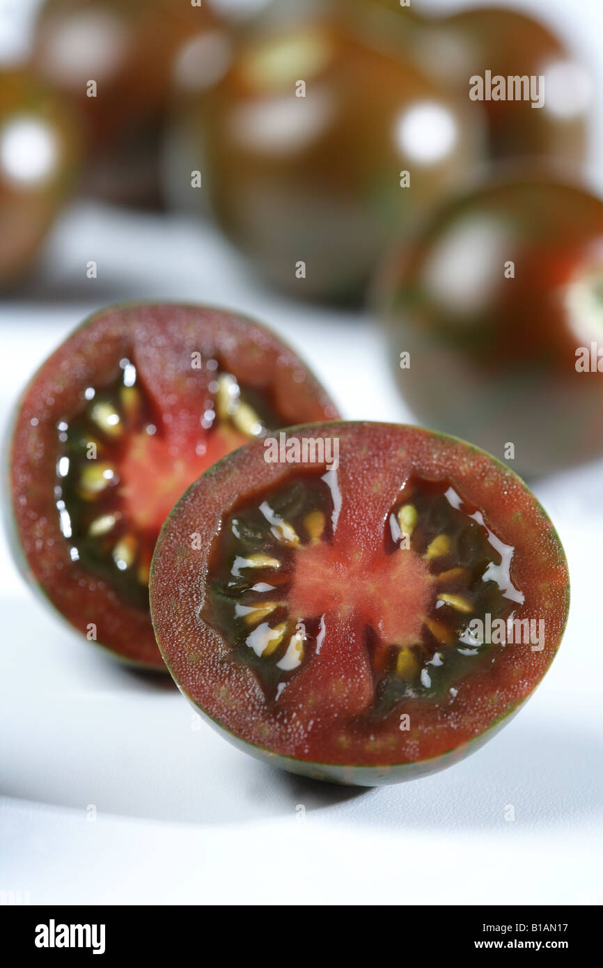 Tiger-striped tomatoes (one cut in half, close up Stock Photo - Alamy