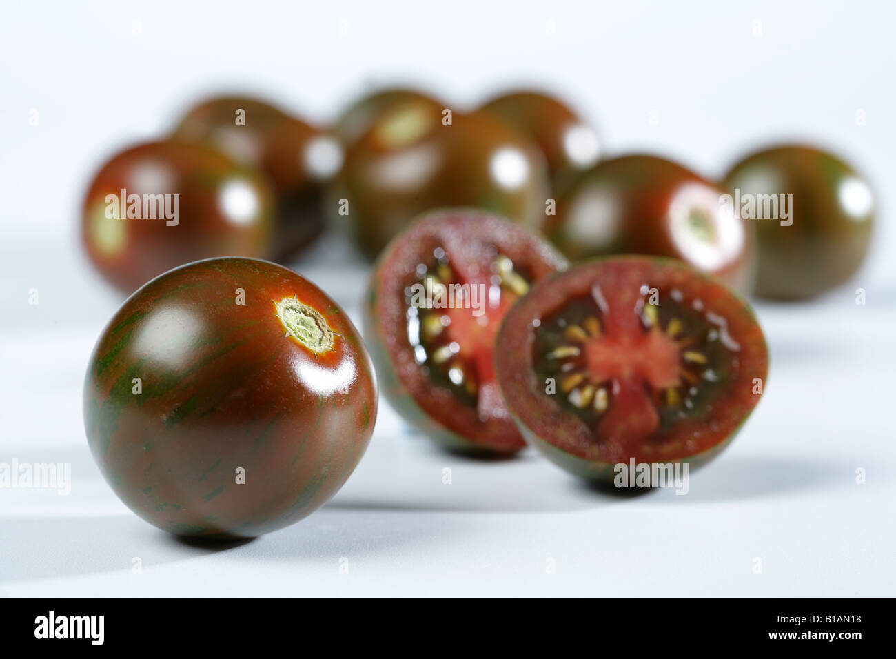 Tiger-striped tomatoes (one cut in half Stock Photo - Alamy