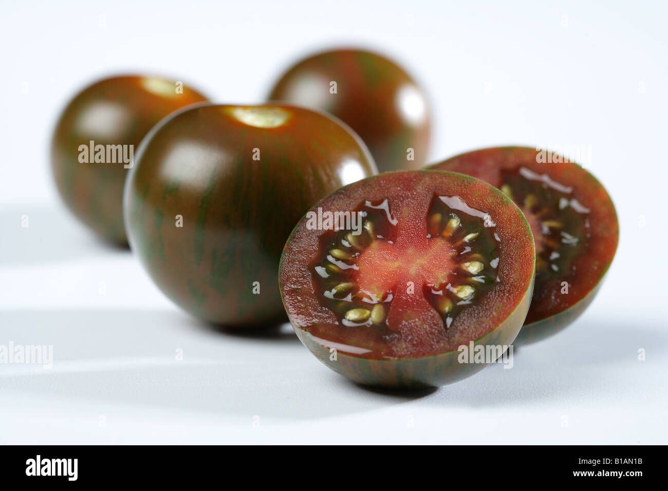 Tiger-striped tomatoes (one cut in half Stock Photo - Alamy