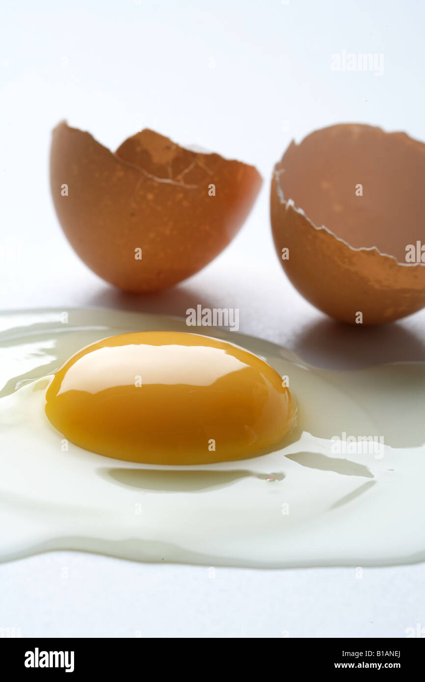 Raw egg on white background with its shell beside Stock Photo - Alamy