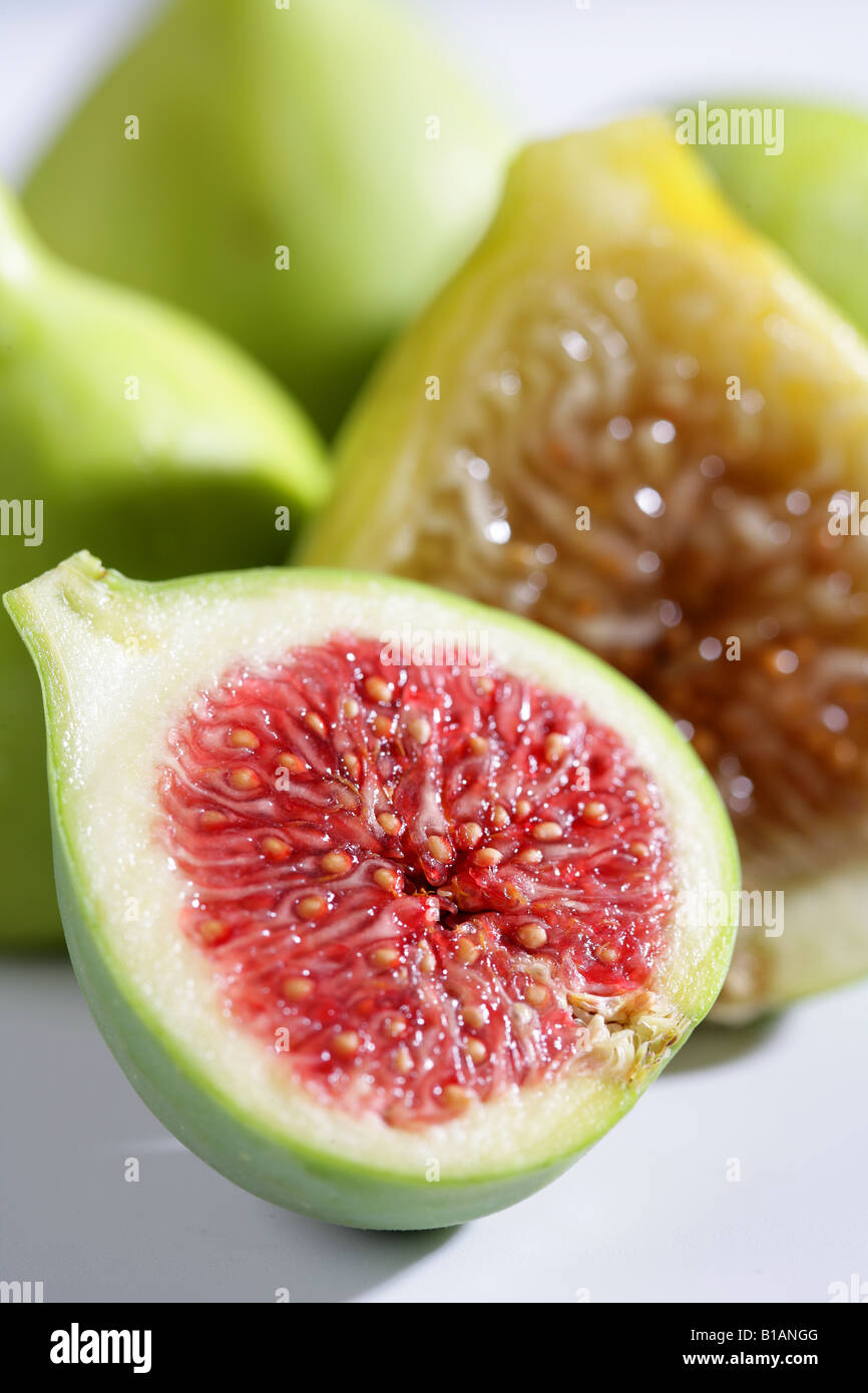 Close-up of an opened fig with more figs in a white background Stock ...