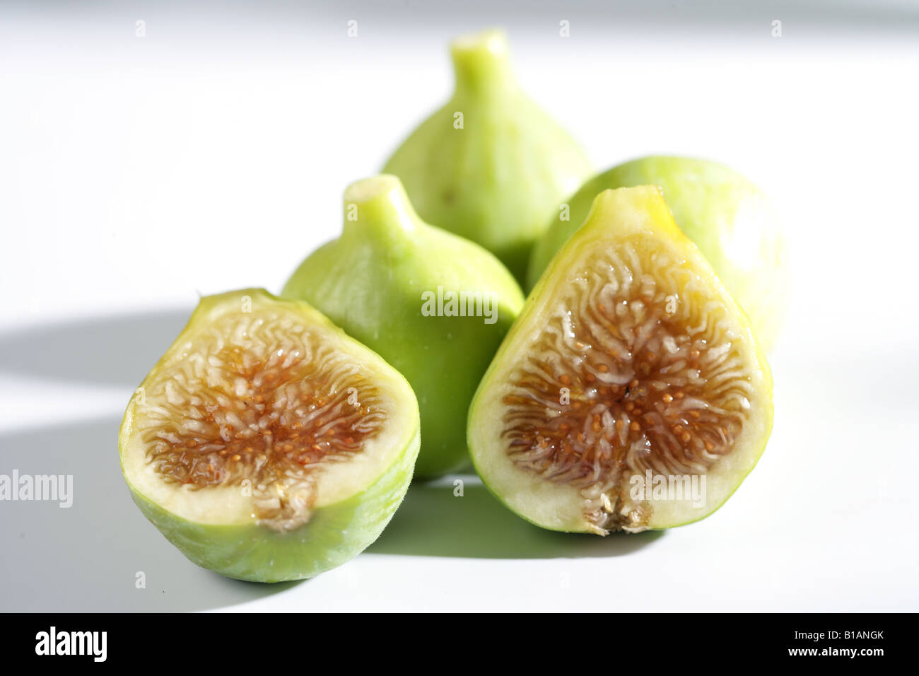 Close-up of an opened fig with whole figs and white background Stock ...