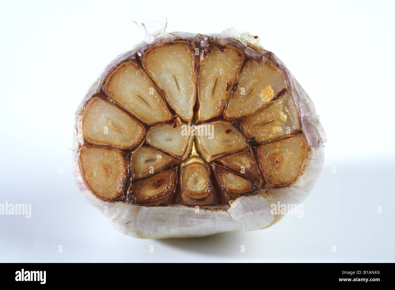 Cut and roasted head of garlic Stock Photo - Alamy
