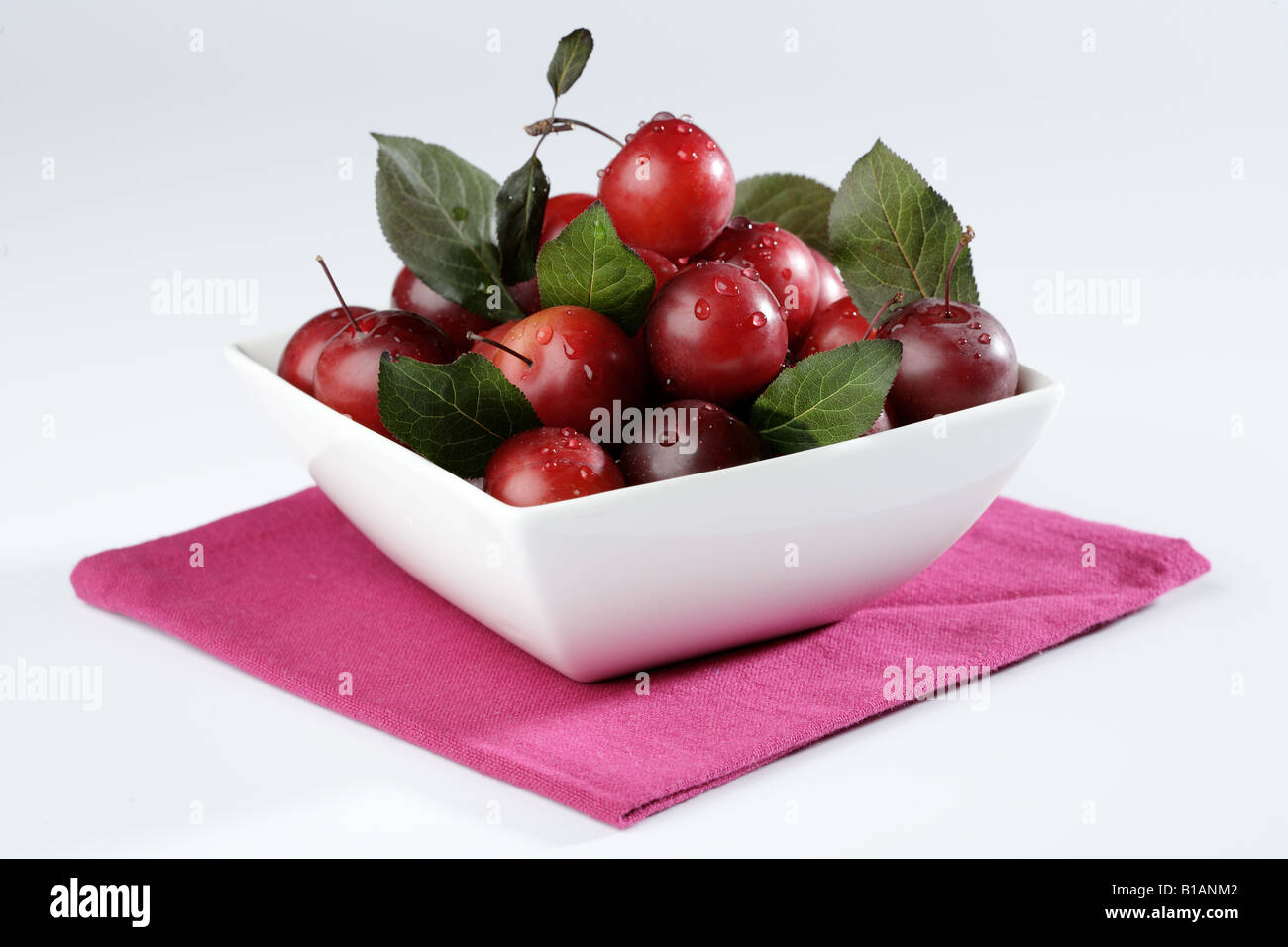 Freshly harvested plums on a purple cloth Stock Photo - Alamy