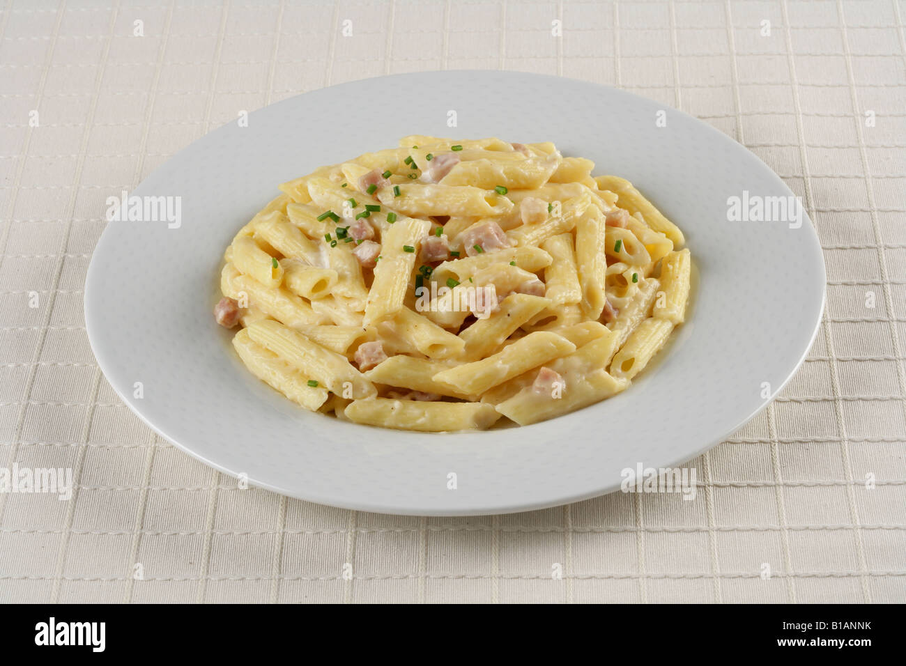 Penne with bechamel sauce and cooked ham Stock Photo - Alamy