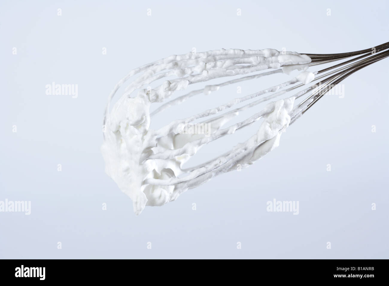 Detail of the whisk with whipped cream Stock Photo - Alamy