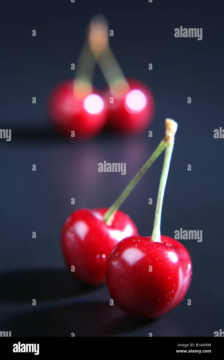 Cherries on black background Stock Photo - Alamy