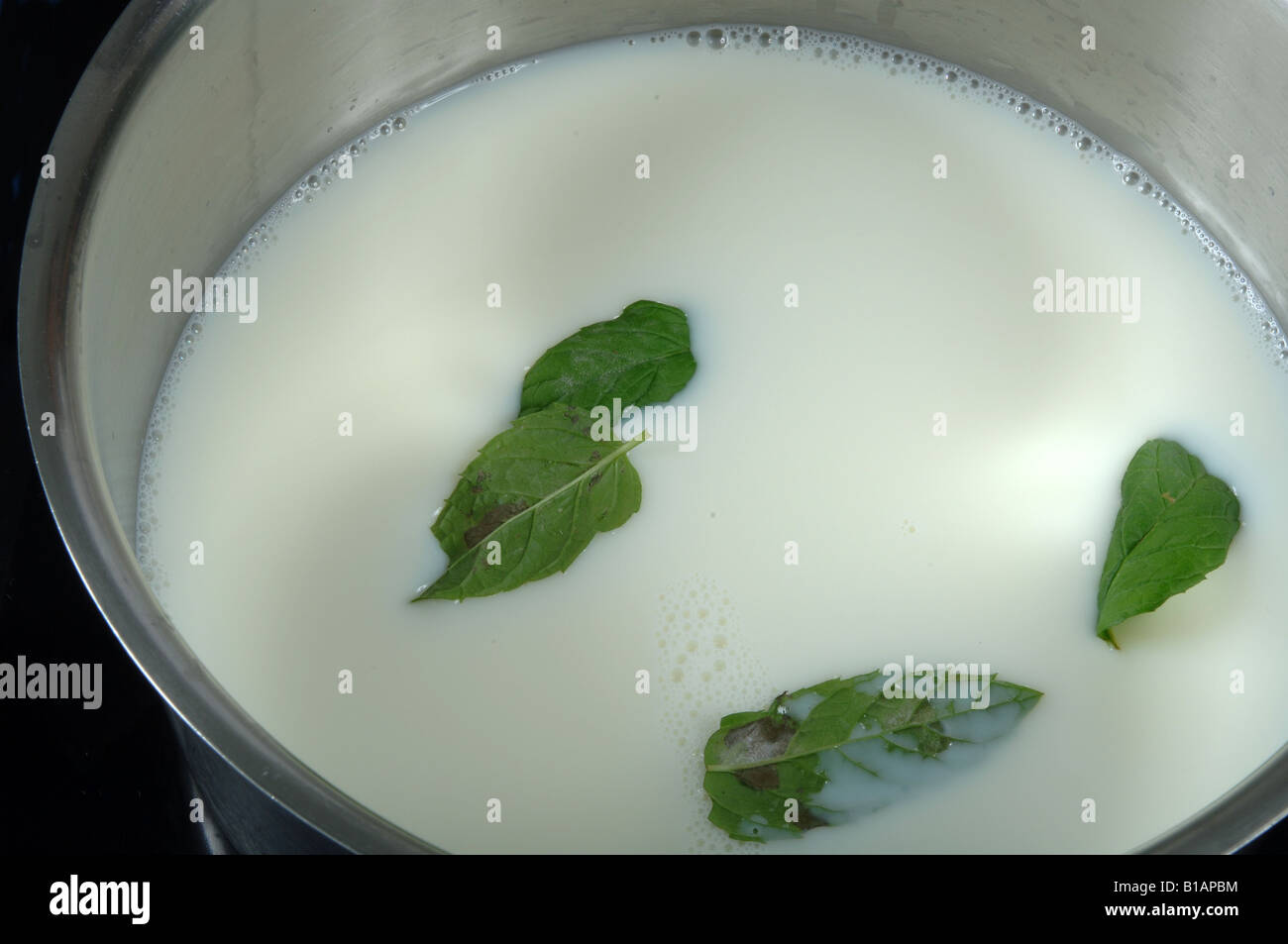 Flavouring milk to make Spanish hot chocolate Stock Photo - Alamy