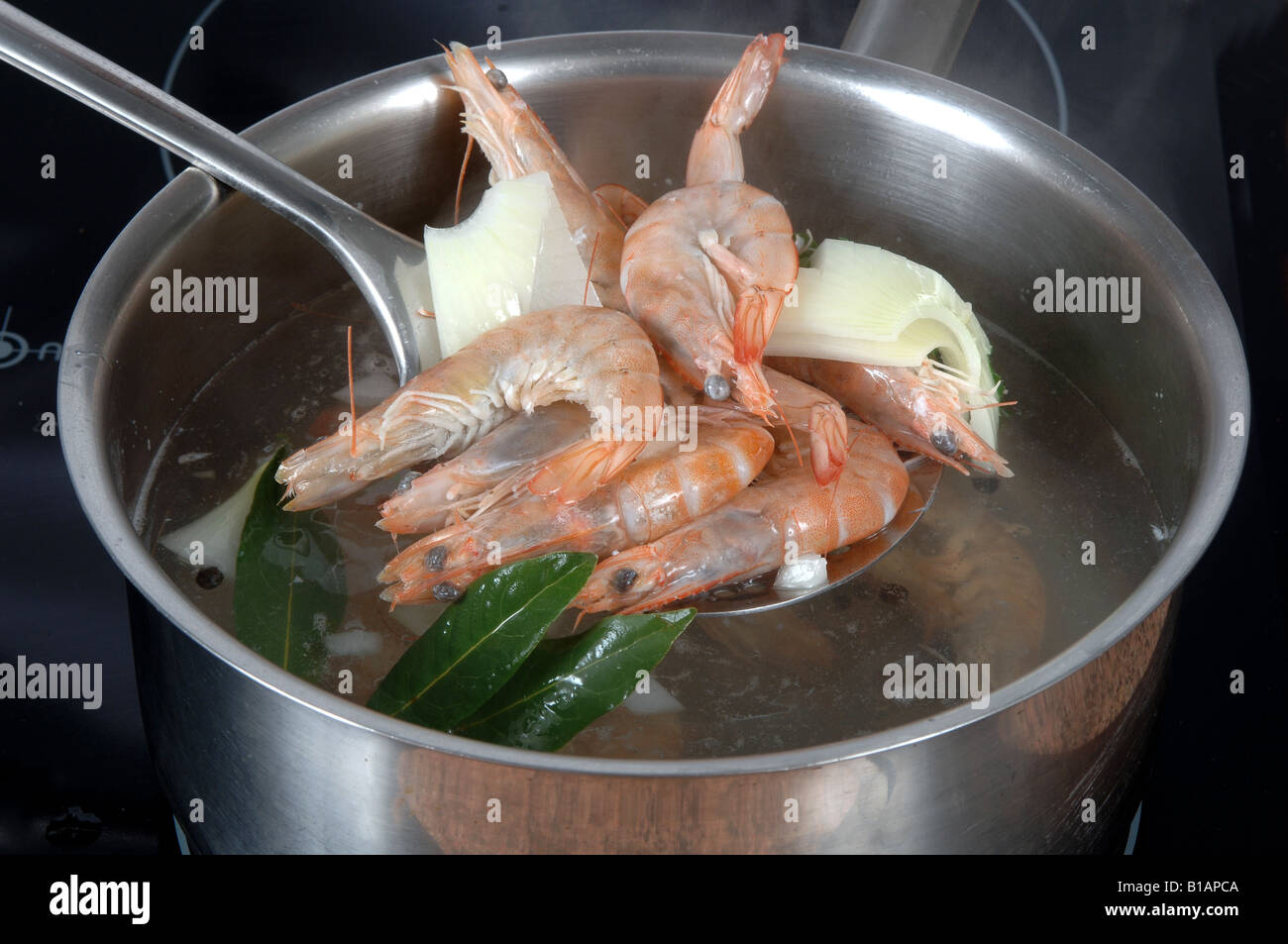 Putting seafood under boiling water Stock Photo - Alamy