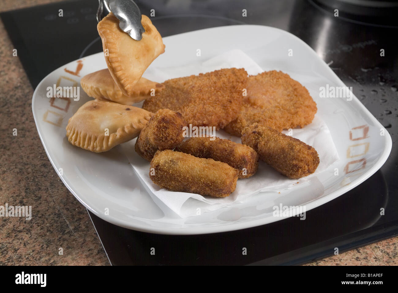 Putting frozen breadcrumbed food on absorbing paper Stock Photo - Alamy
