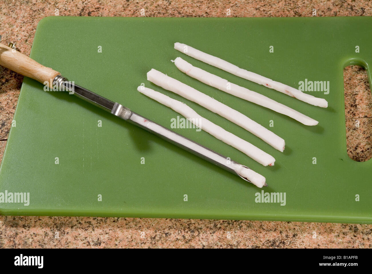Cutting bacon rashers; putting them into meat fryer Stock Photo - Alamy
