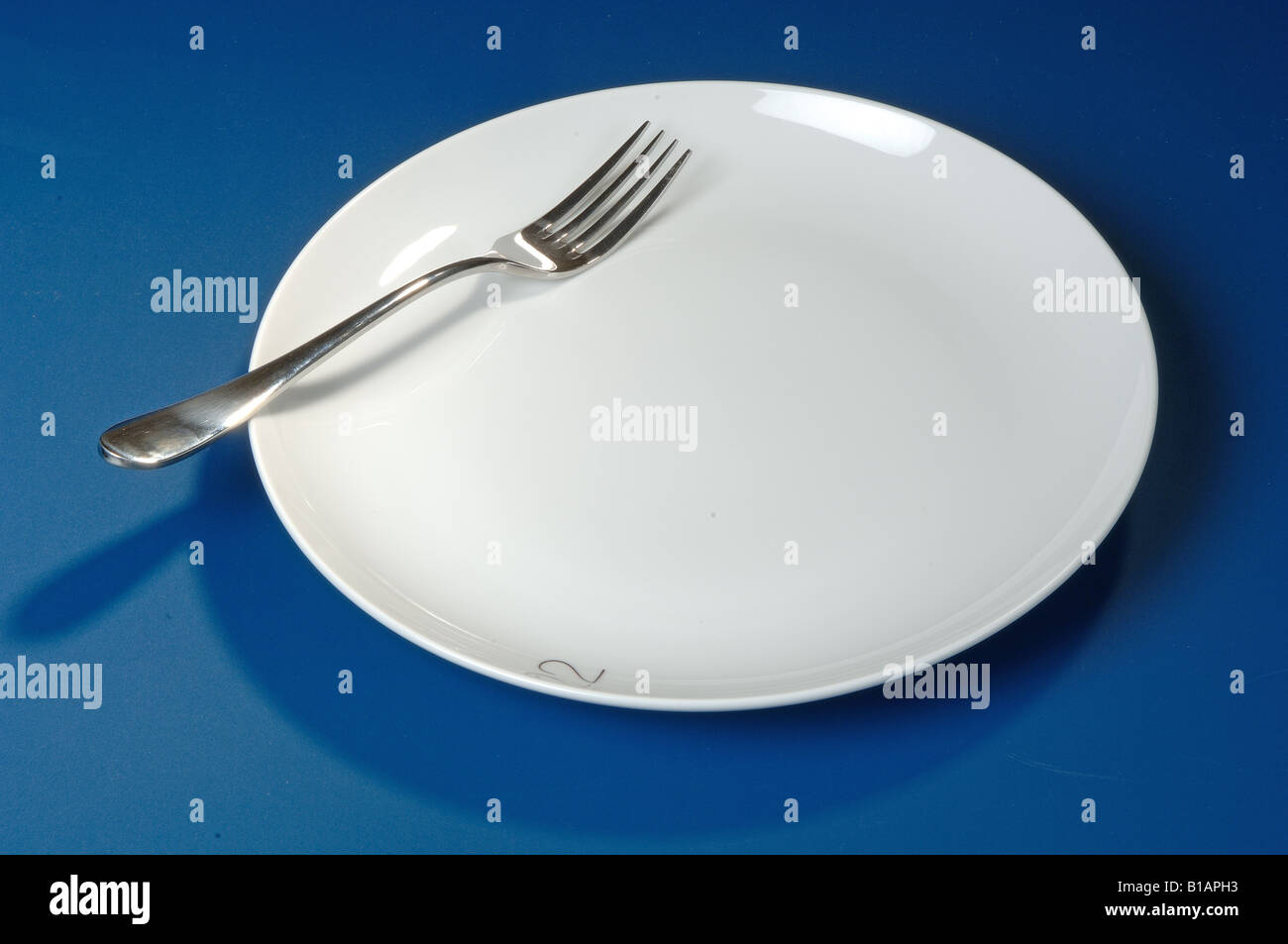 Plate and fork Stock Photo - Alamy