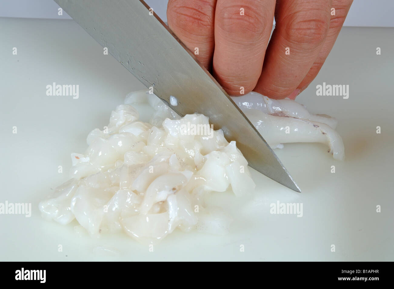 Cutting cuttlefish into very thin slices Stock Photo - Alamy