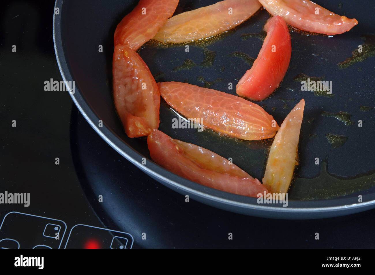 Making sautéed sliced tomato Stock Photo - Alamy