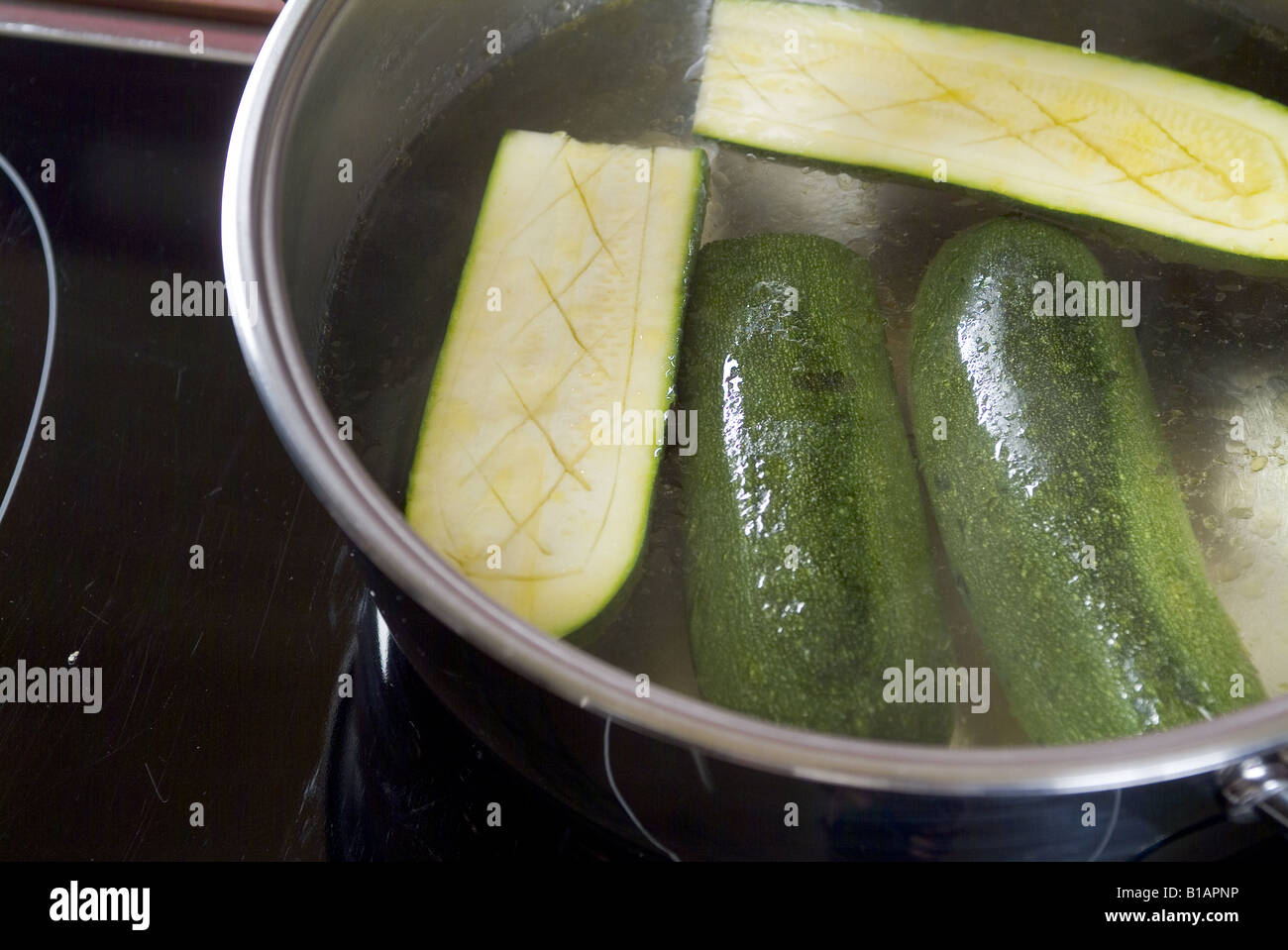 Cooking chopped courgettes Stock Photo - Alamy