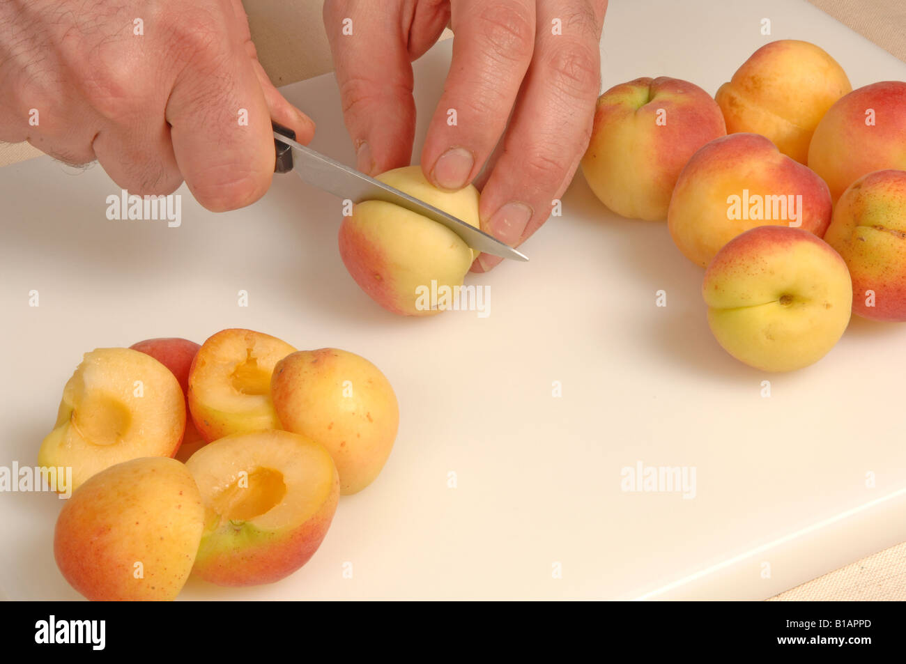 Cutting apricot into halves Stock Photo - Alamy