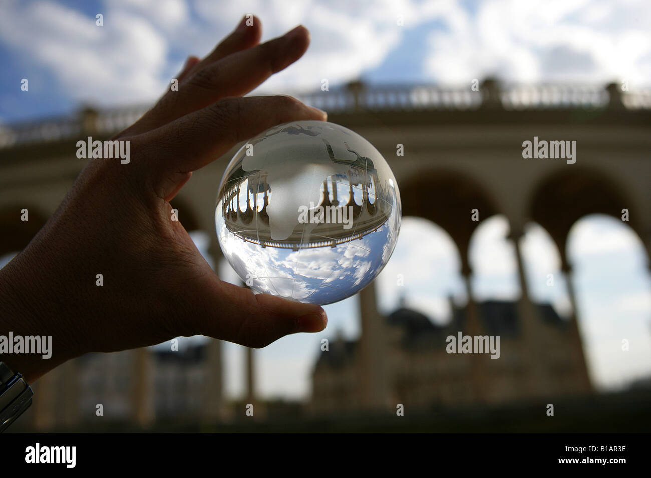 one man holding a crystal ball Stock Photo - Alamy