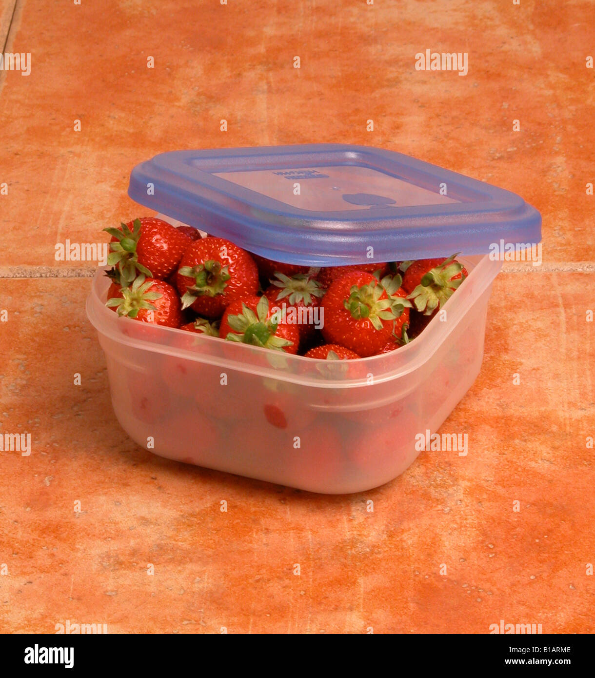 Small plastic ware large strawberries Stock Photo - Alamy