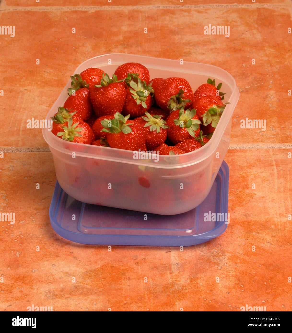 Small plastic ware large strawberries Stock Photo - Alamy