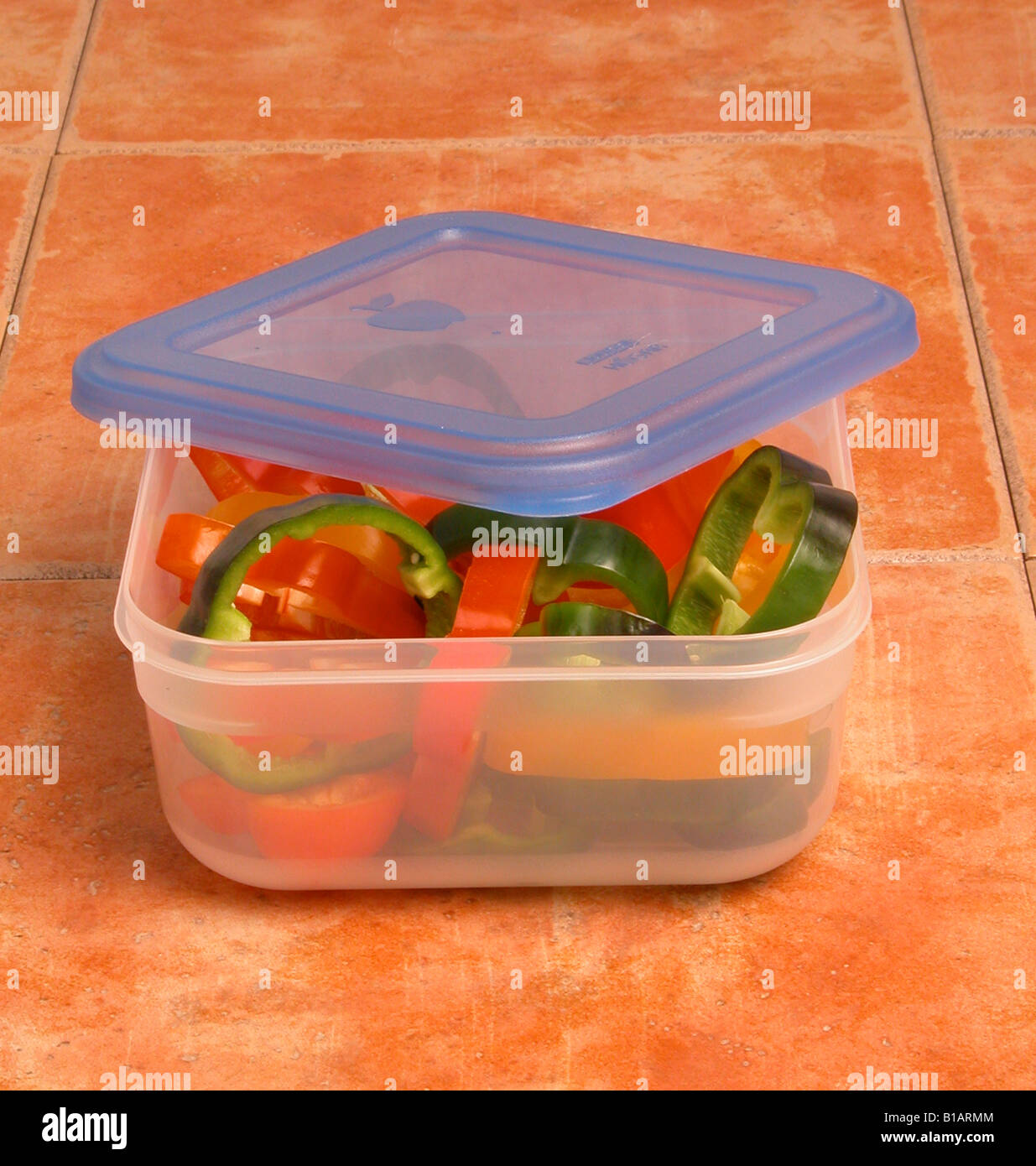 Large plastic ware with colour peppers Stock Photo - Alamy