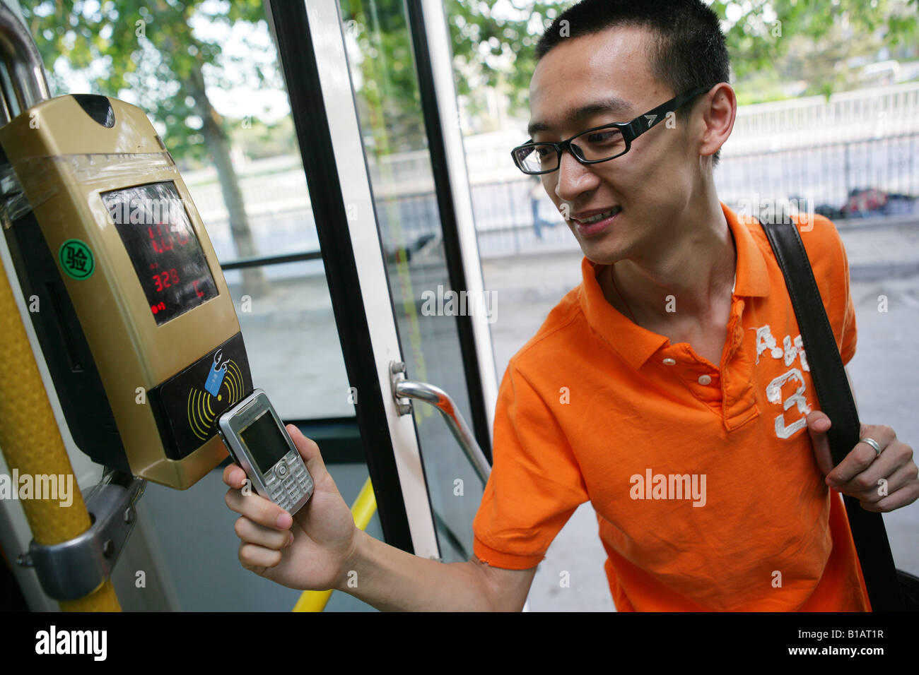 a chinese young man taking a bus Stock Photo - Alamy